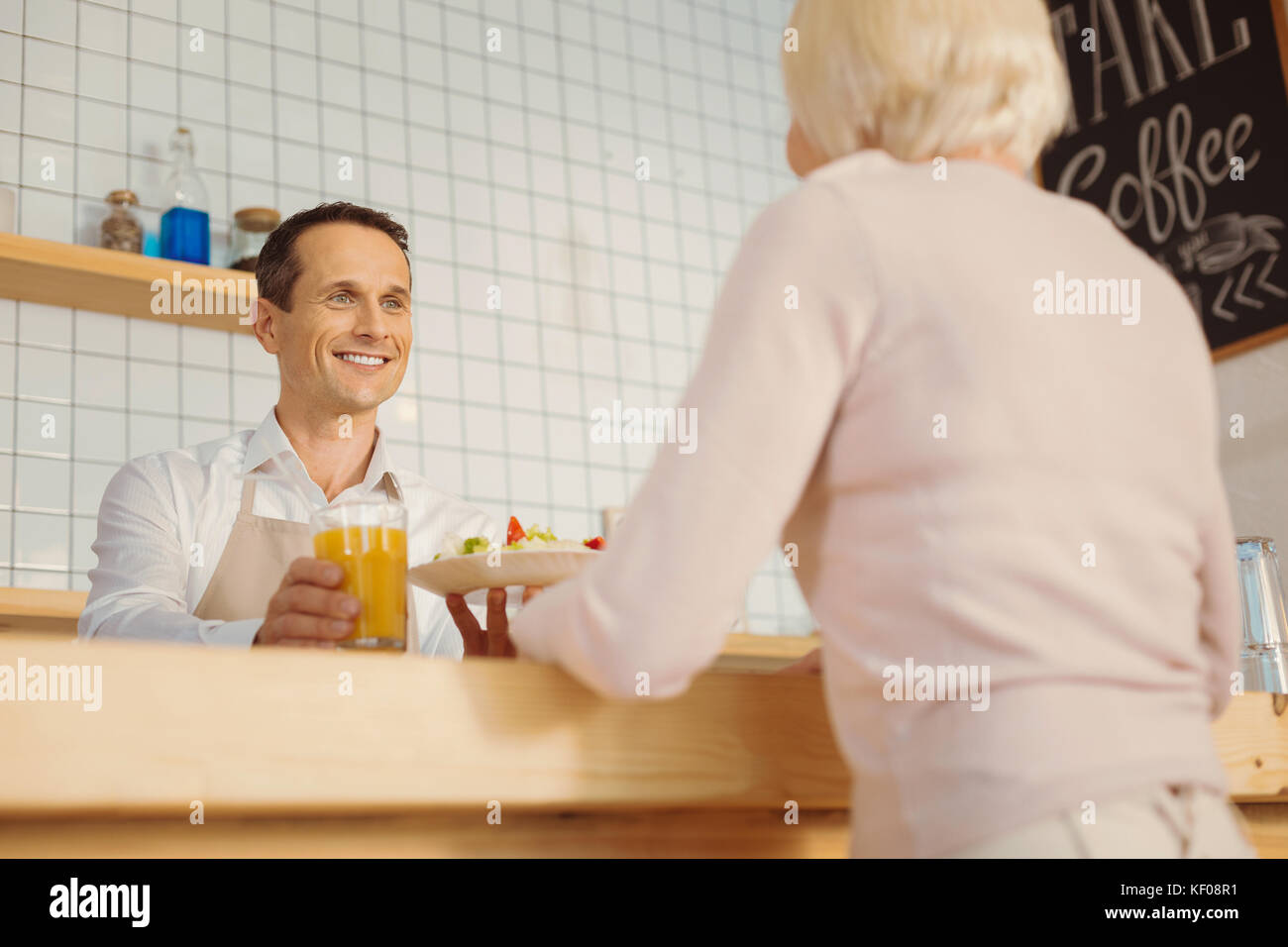 Happy friendly man giving the order Stock Photo - Alamy