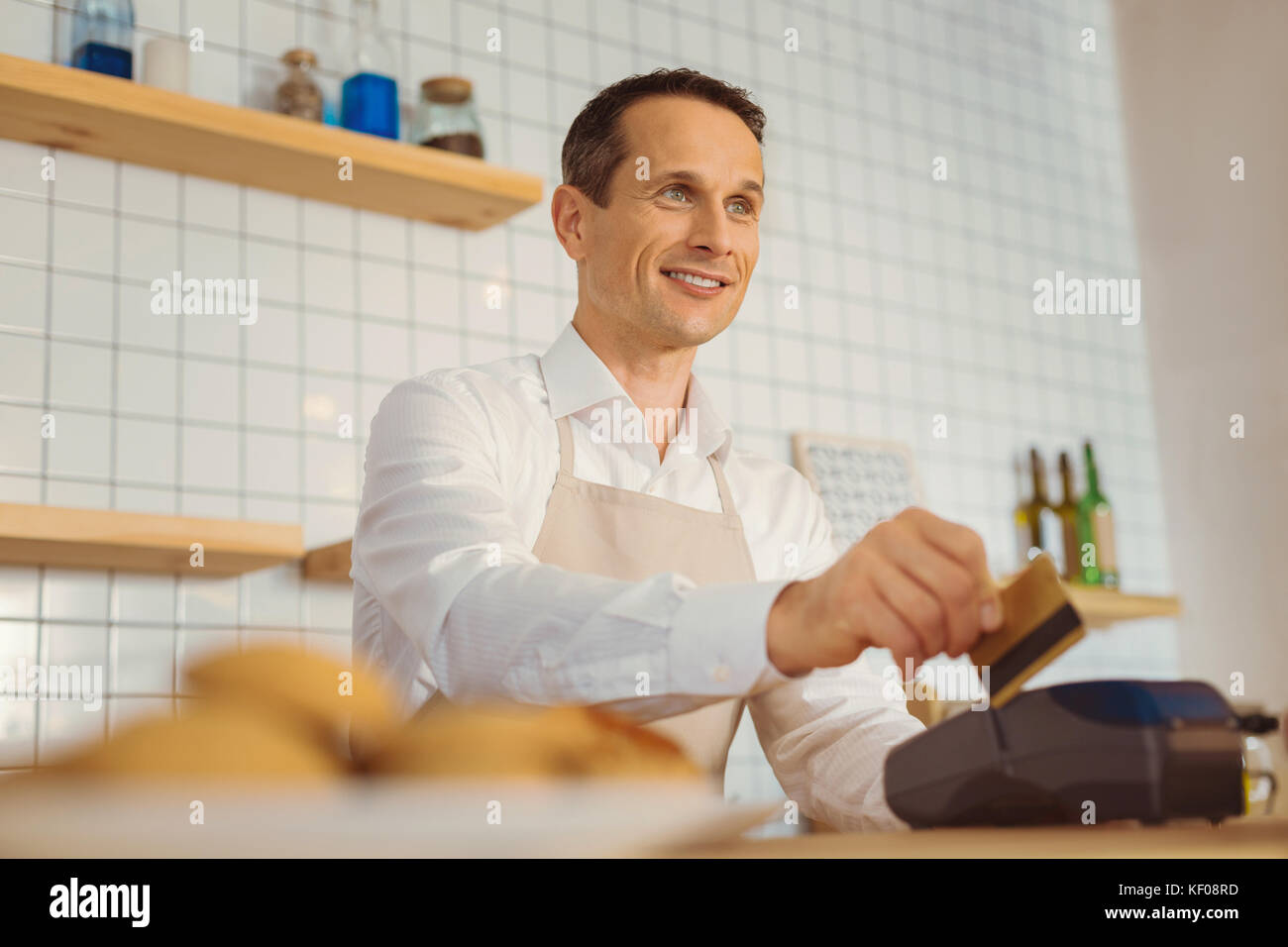 Nice good looking man holding a credit card Stock Photo - Alamy