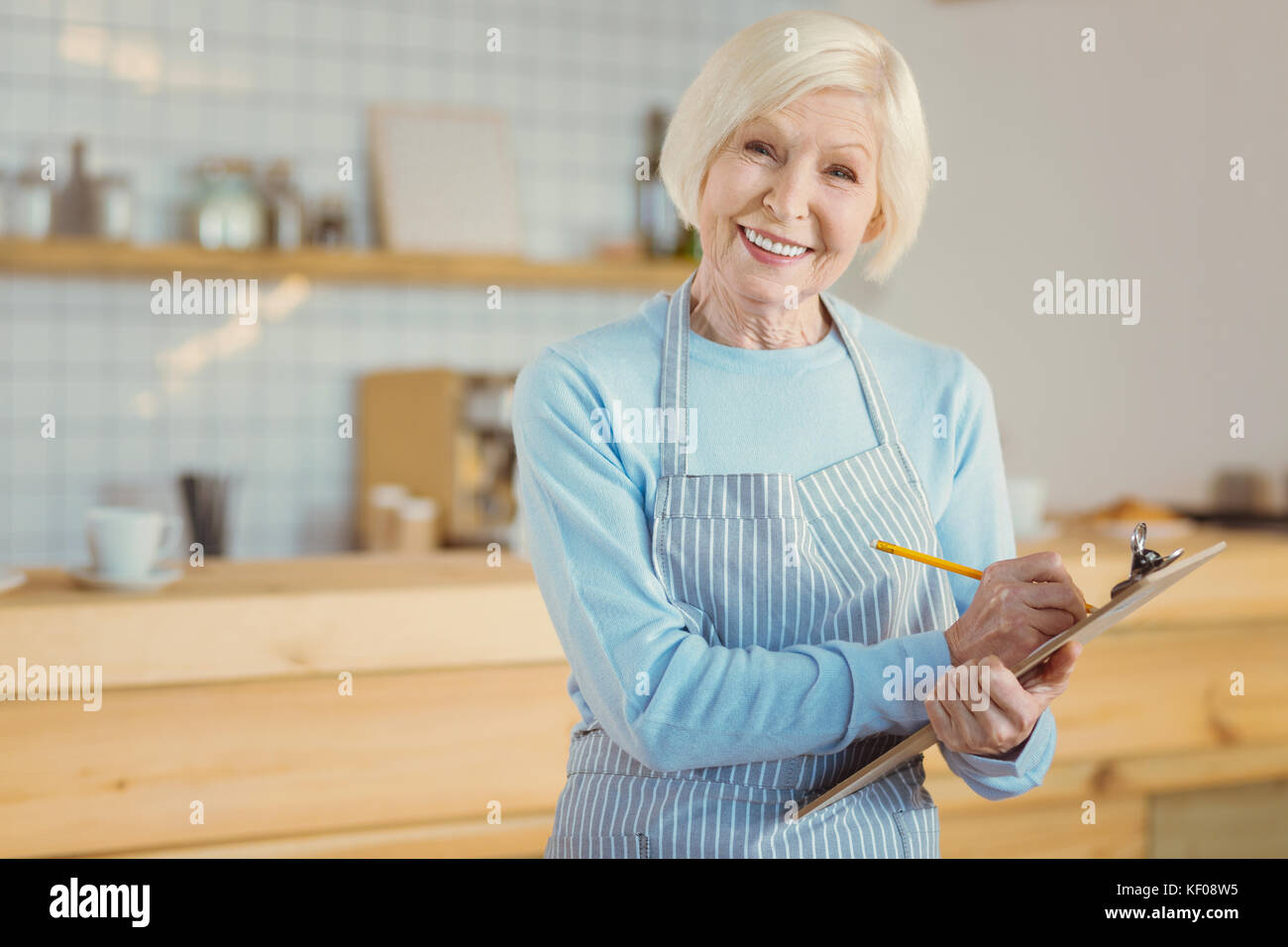 Happy cheerful woman taking notes Stock Photo - Alamy