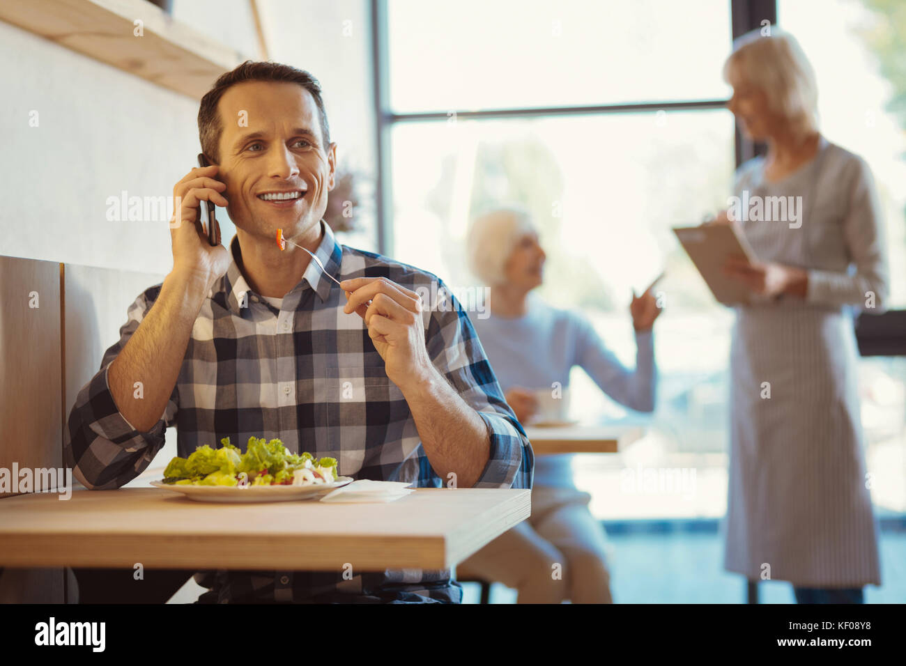 Smart happy man enjoying his food Stock Photo - Alamy