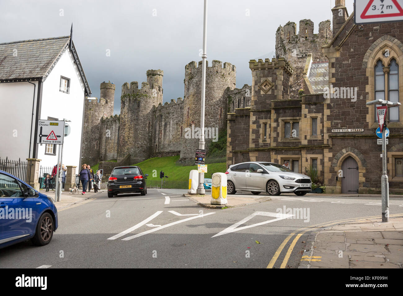 Conwy town high street scene, castle in background Stock Photo - Alamy