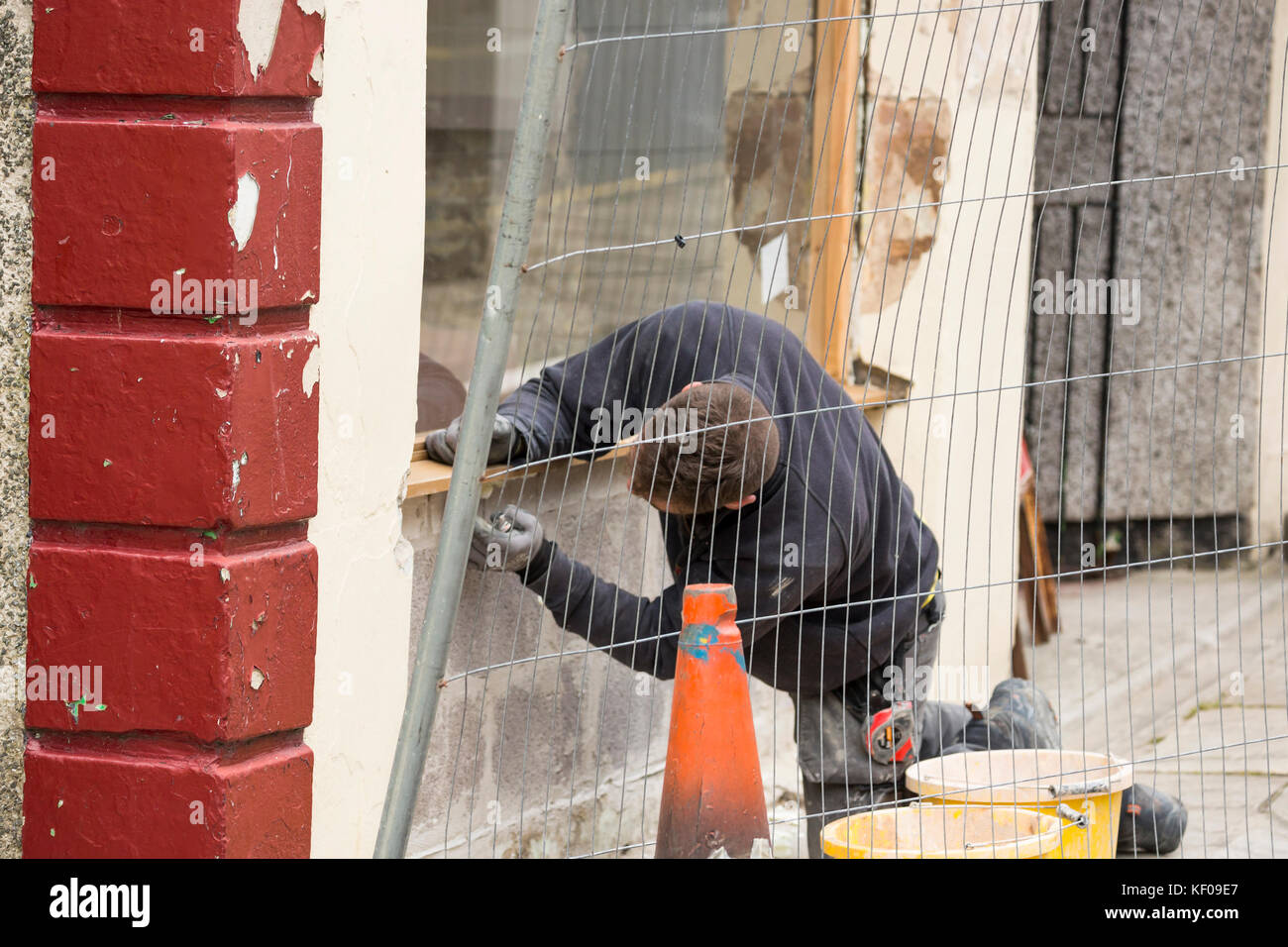 builder renovating high strret shop exterior Stock Photo - Alamy