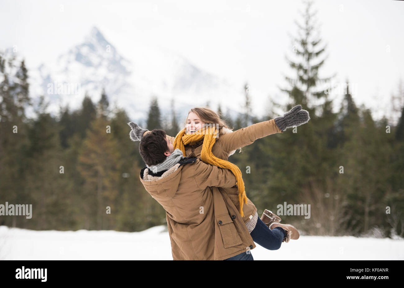 Happy young couple having fun in winter landscape Stock Photo - Alamy