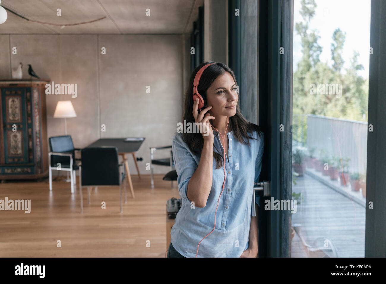 Relaxed woman listening to music at home Stock Photo - Alamy