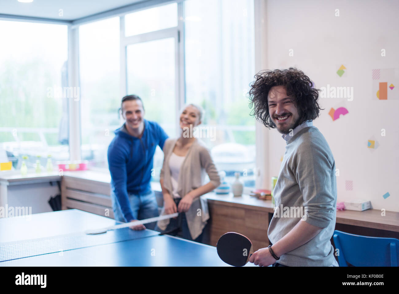 group of young startup business people playing ping pong tennis at ...