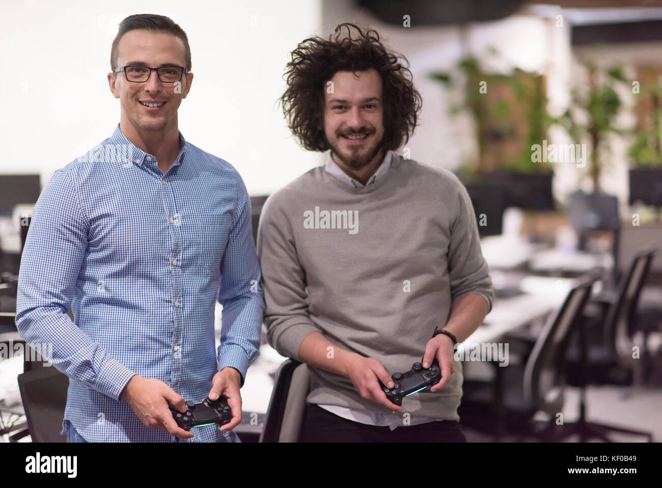 Work hard play hard. Workers Playing computer games in creative startup ...