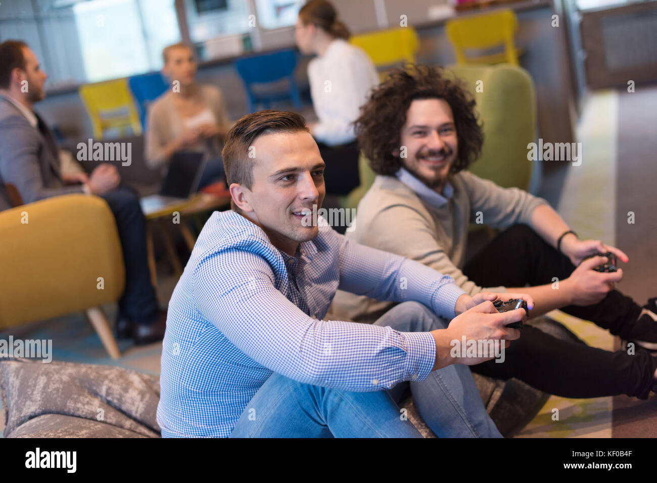 Work hard play hard. Workers Playing computer games in creative startup ...