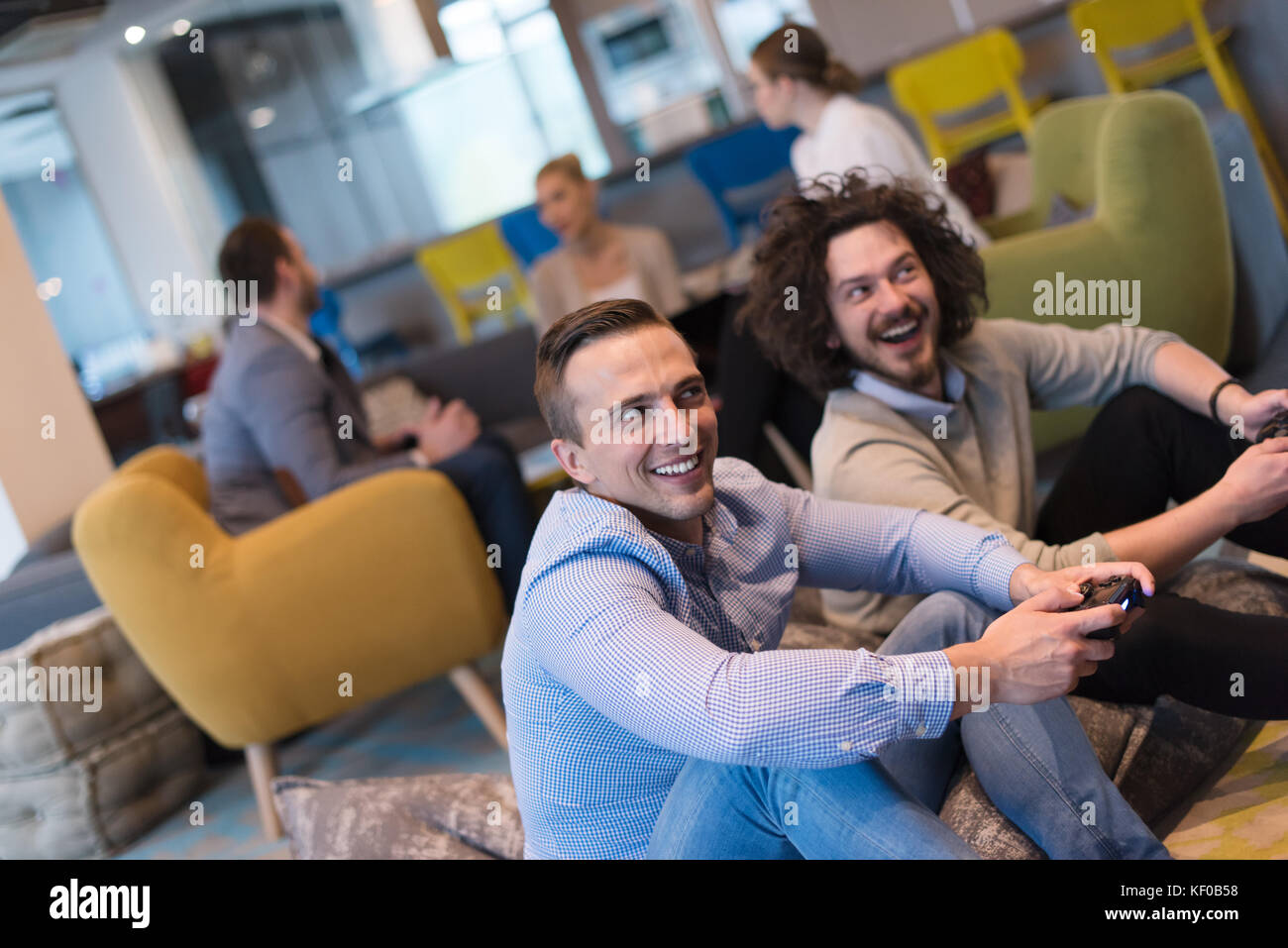 Work hard play hard. Workers Playing computer games in creative startup ...