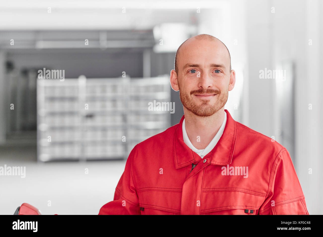 Portrait of smiling man in factory Stock Photo - Alamy