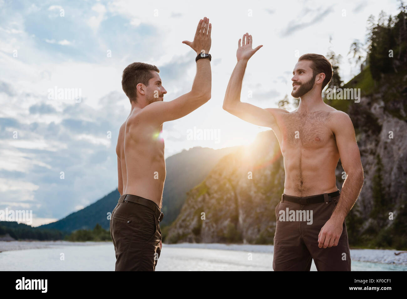 Germany, Bavaria, two best friends high fiving in nature Stock Photo ...