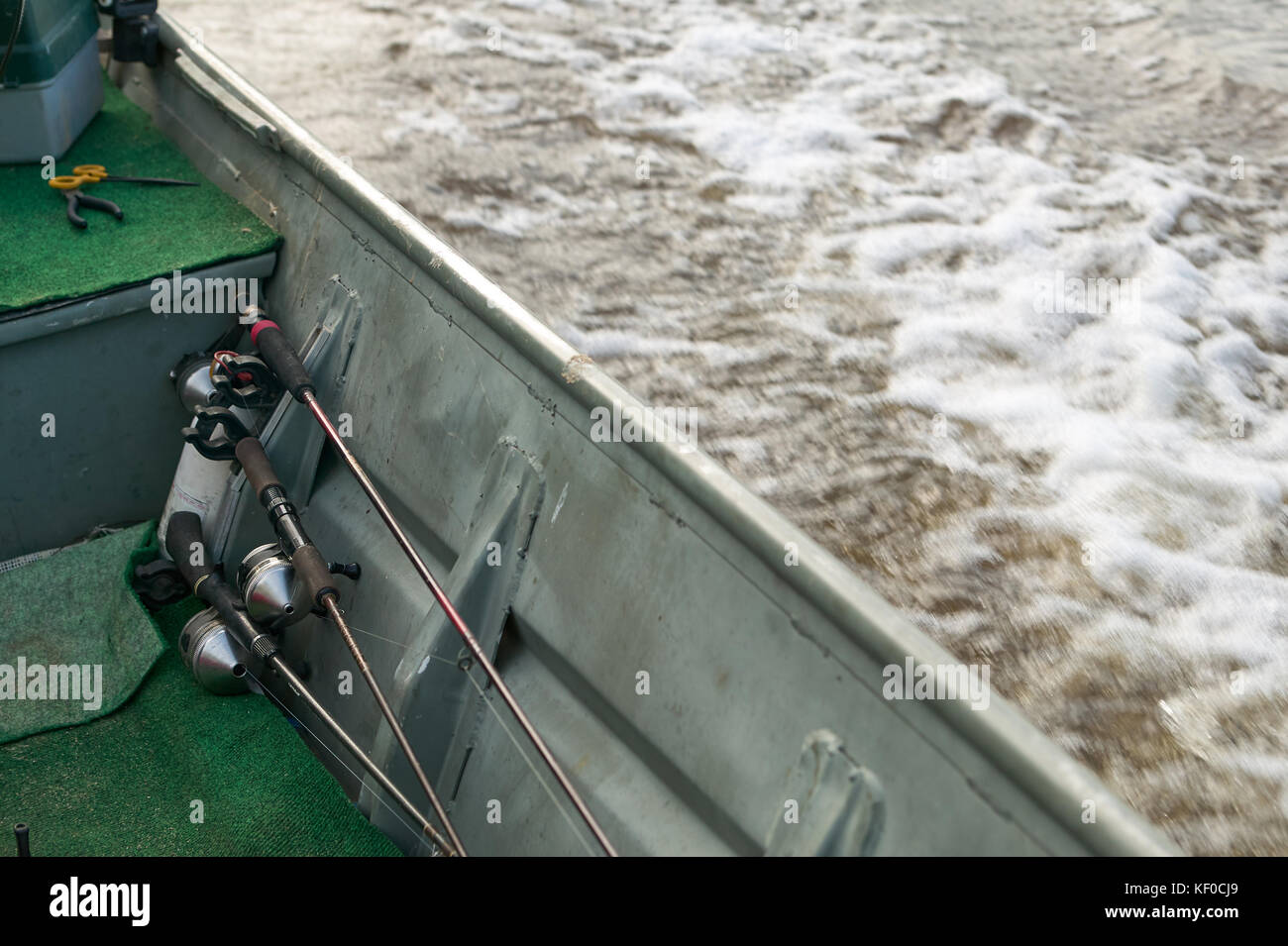 An abstract crop of fishing rods and equipment inside a motorboat as it ...