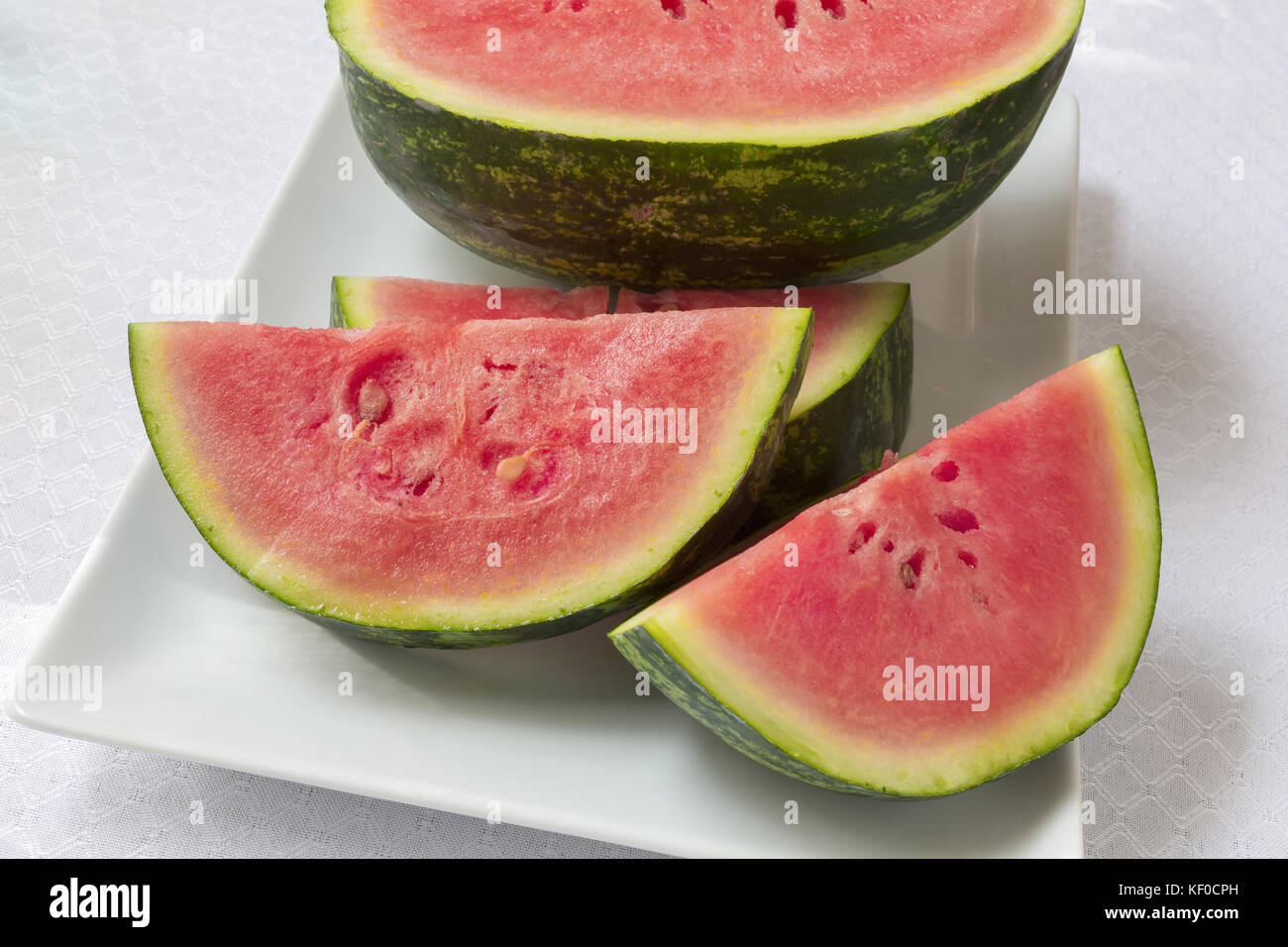 Freshly cut small watermelon on a tray Stock Photo - Alamy