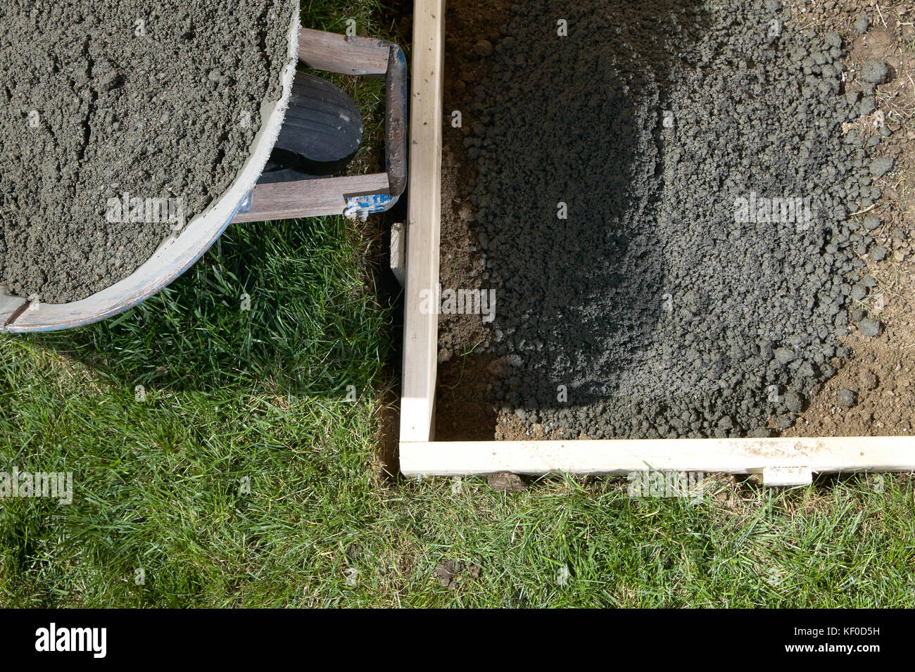 A backyard, DIY home concreting project close up with wet cement ...