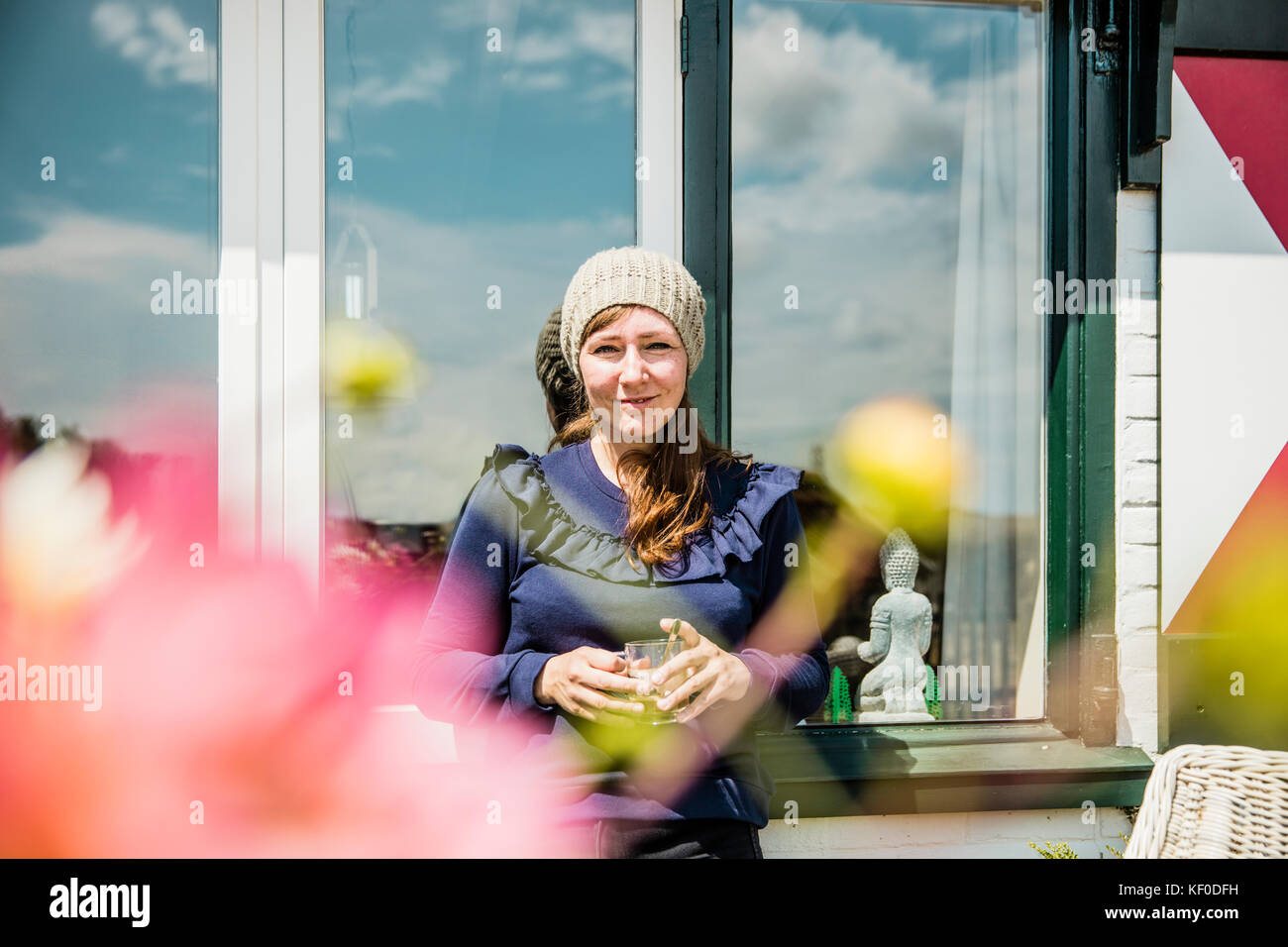 Portrait of smiling woman at a window Stock Photo - Alamy