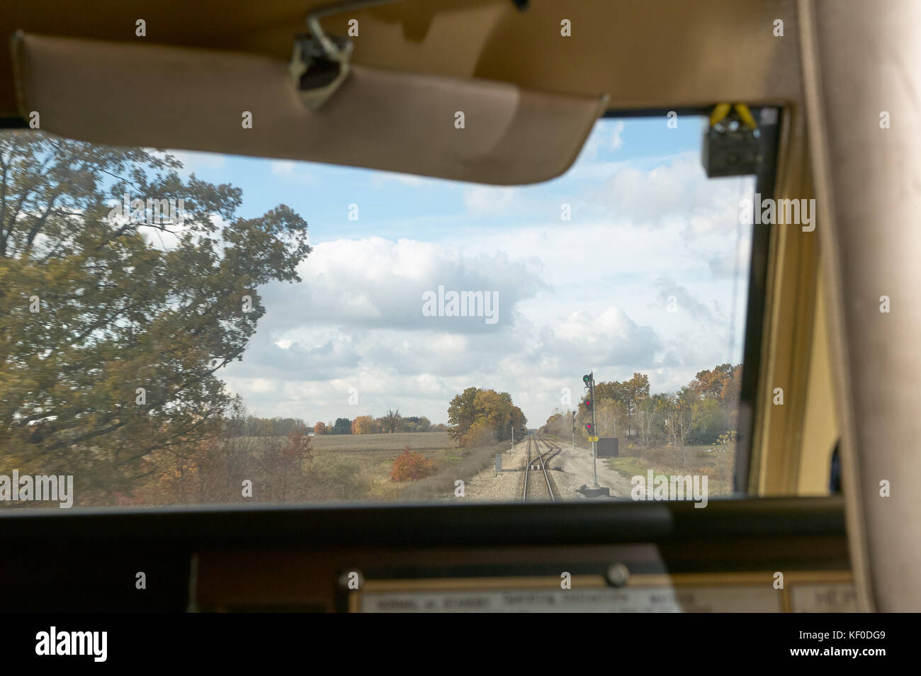 View of outdoor trees and foliage and train tracks through the front ...