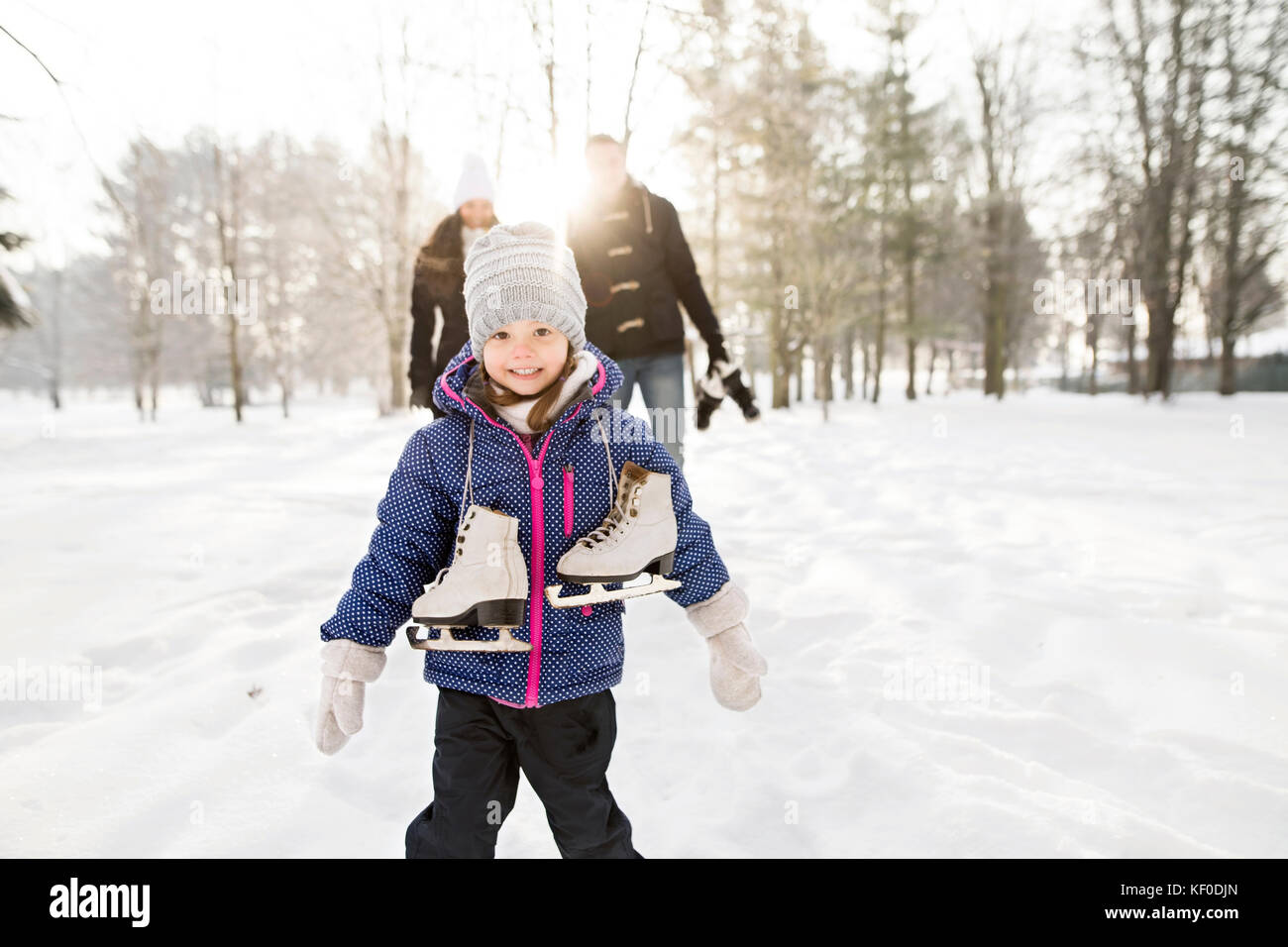 Little girl going ice skating with her parents Stock Photo - Alamy