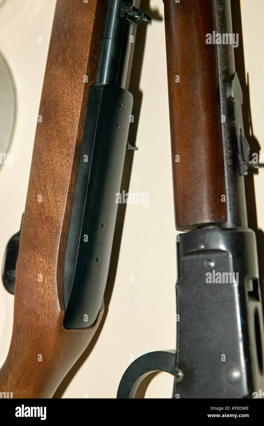 A close up of hunting rifles, triggers and barrels laying on a table ...