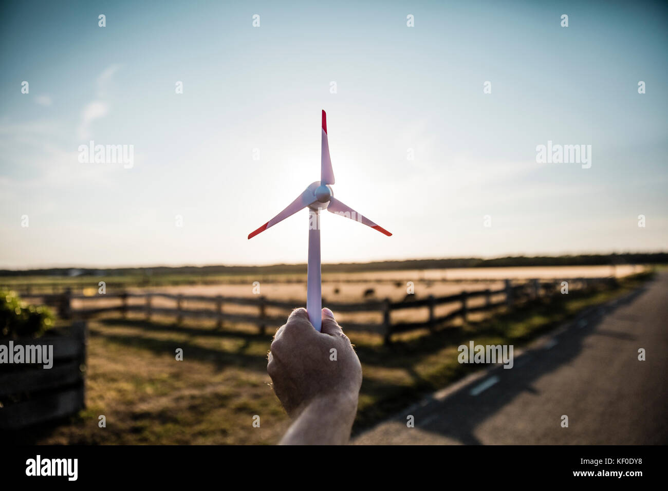 Hand holding miniature wind turbine Stock Photo - Alamy