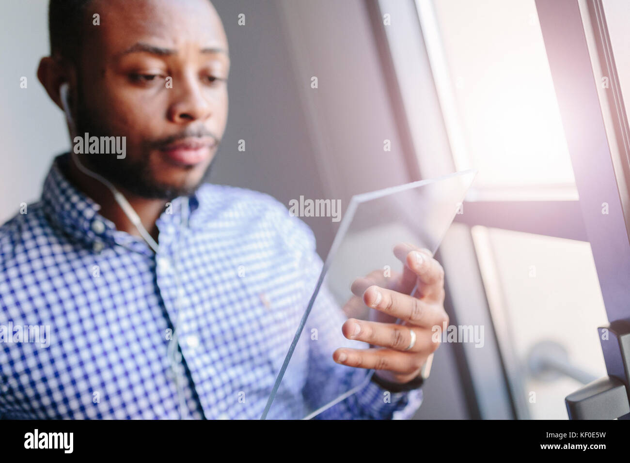 Young man using a futuristic tablet Stock Photo - Alamy