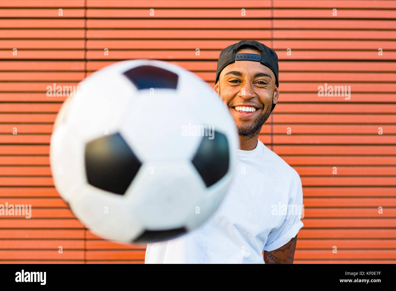 Portrait of laughing man having fun with soccer ball Stock Photo - Alamy