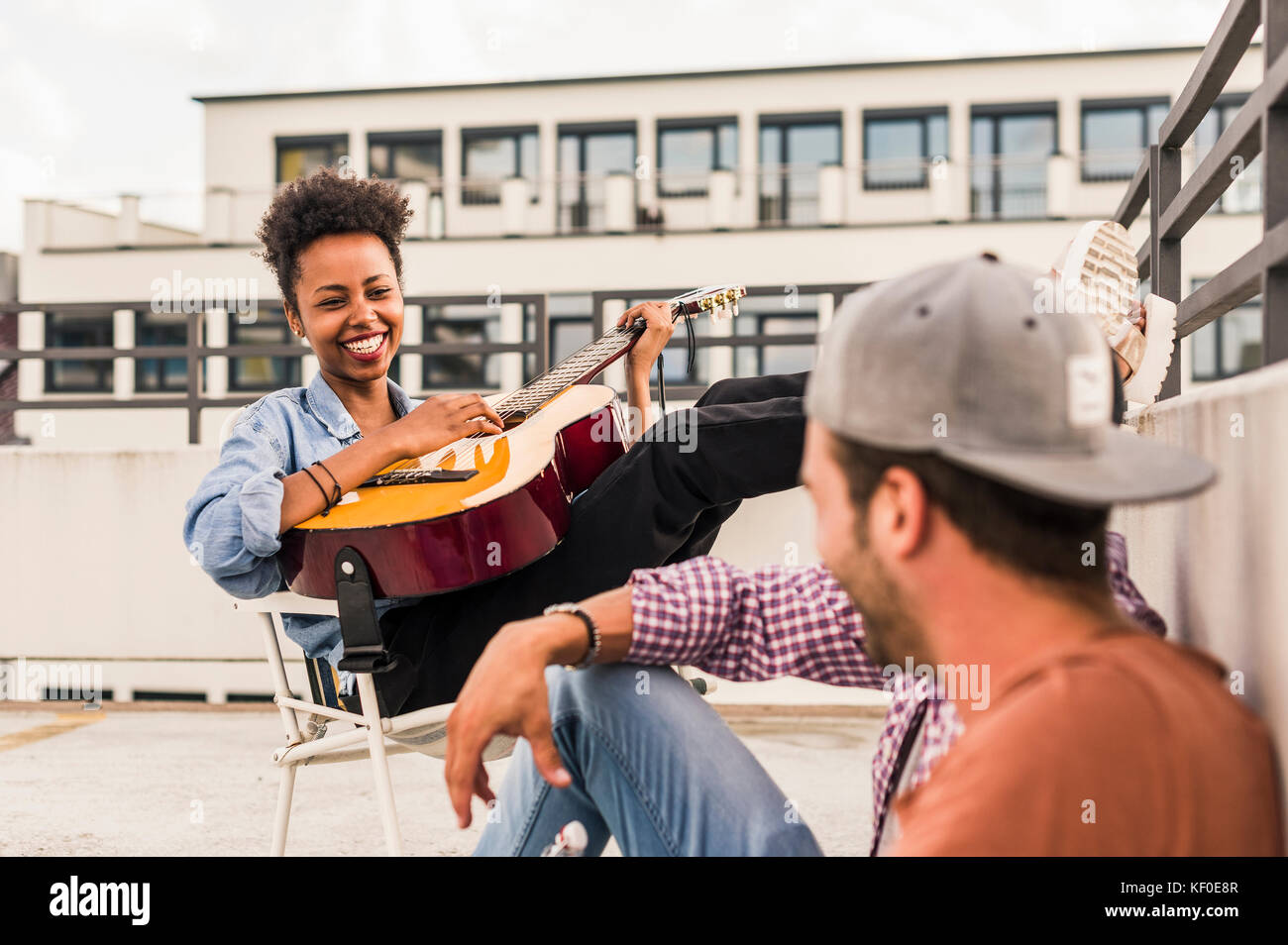 Three friends having a rooftop party Stock Photo - Alamy