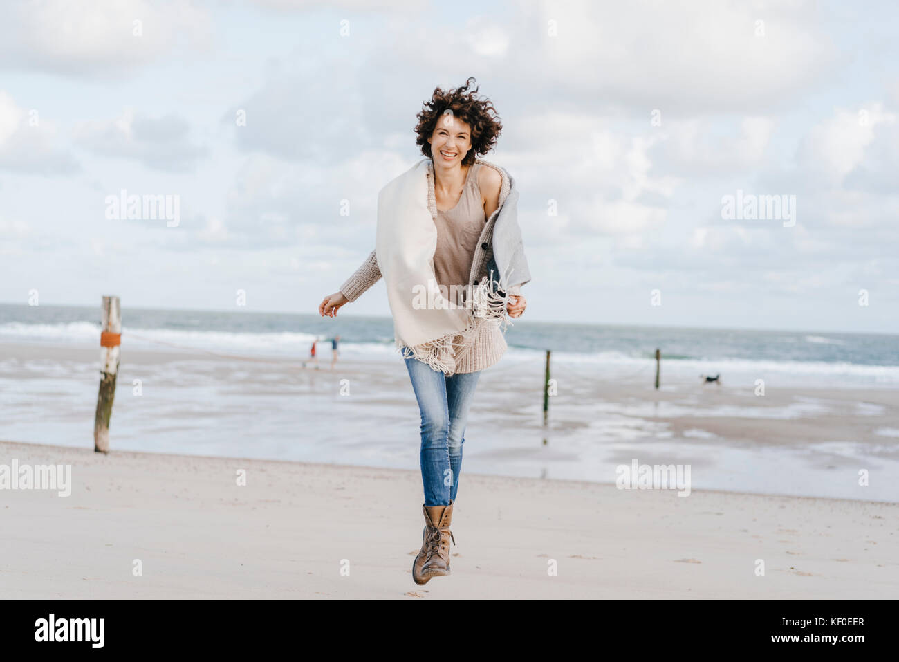 Happy woman running from camera hi-res stock photography and images - Alamy
