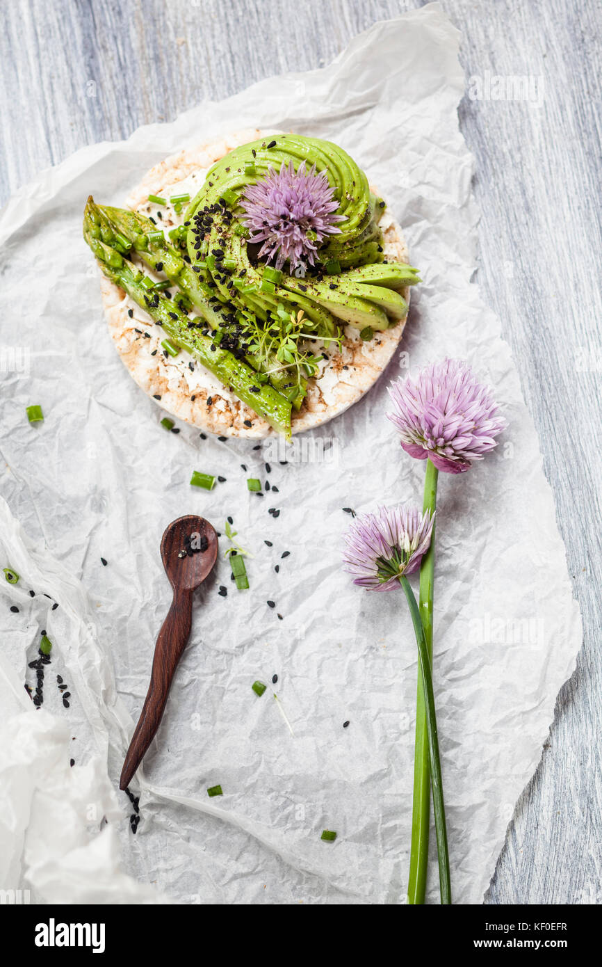 Rice cakes with cream cheese, avocado and asparagus garnished with ...
