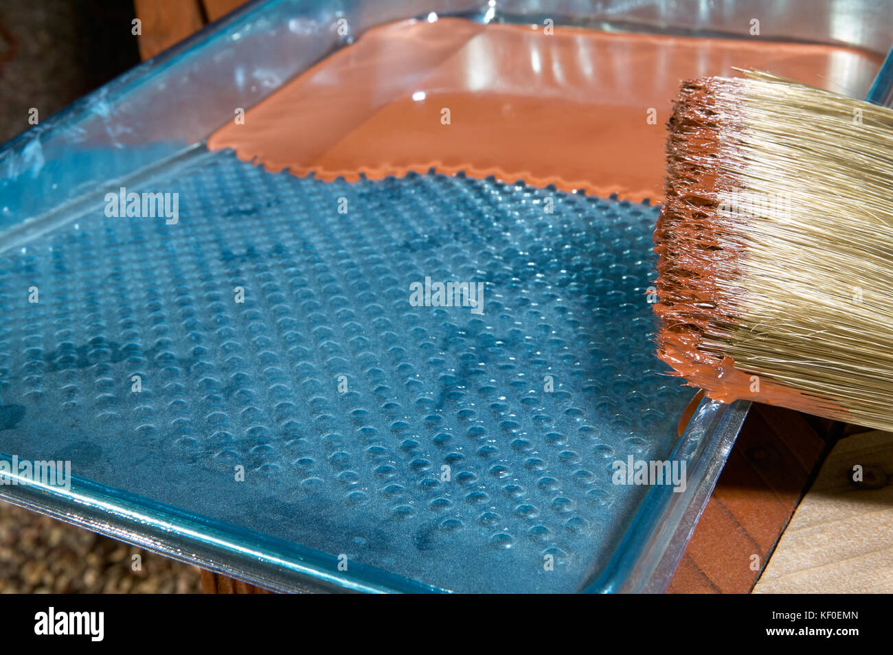 Close up view of paintbrush with brown stain paint on the end of the ...