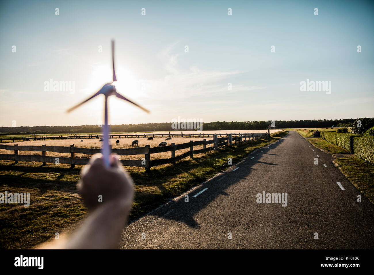 Hand holding miniature wind turbine Stock Photo - Alamy