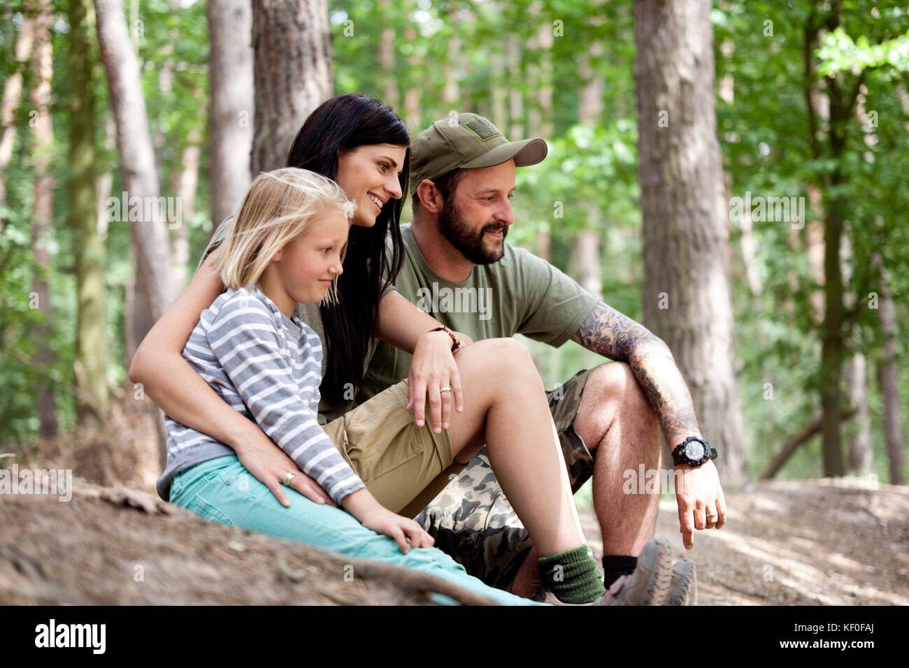 Happy family with daughter in forest Stock Photo - Alamy