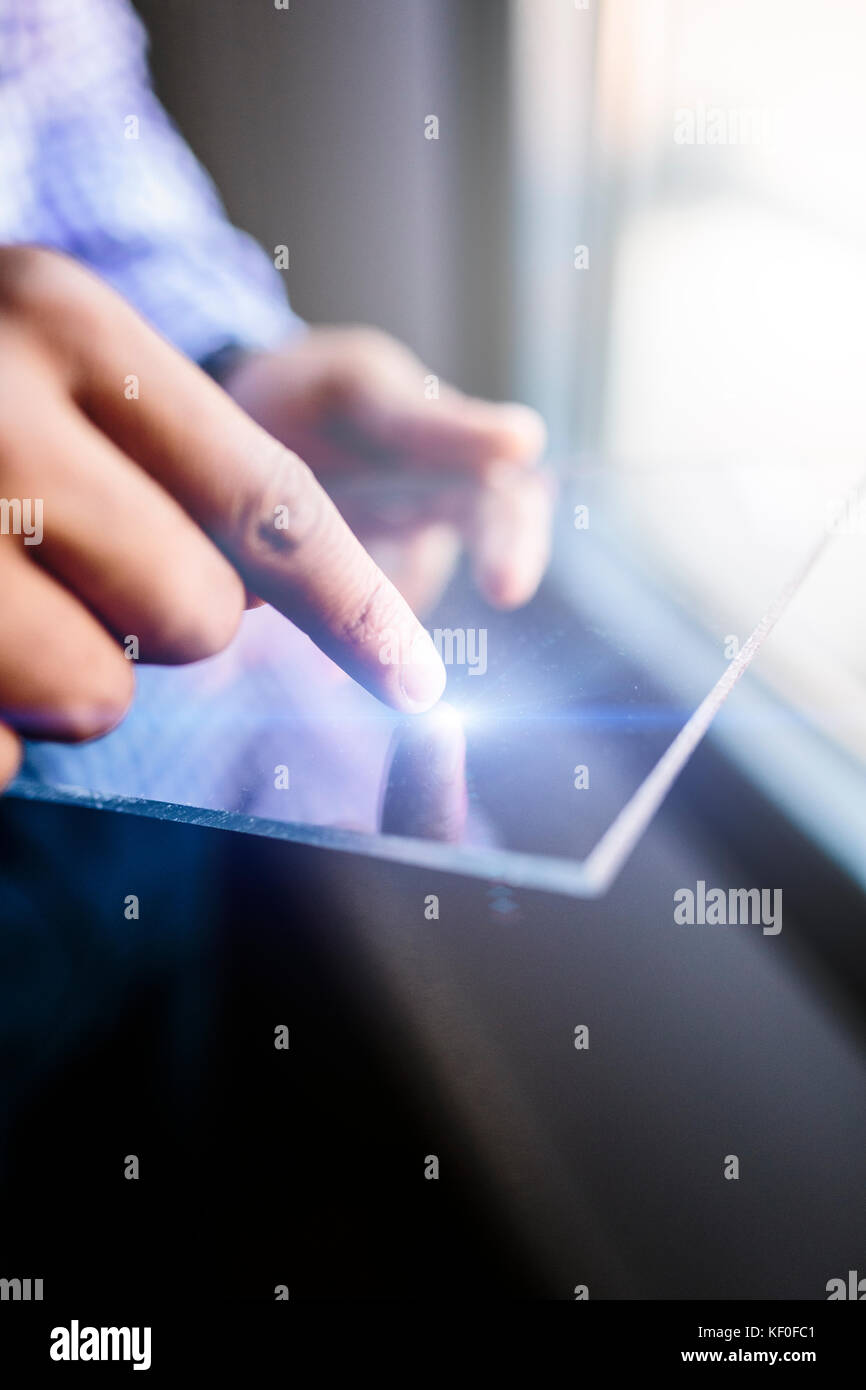 Close-up of man using a futuristic tablet Stock Photo - Alamy