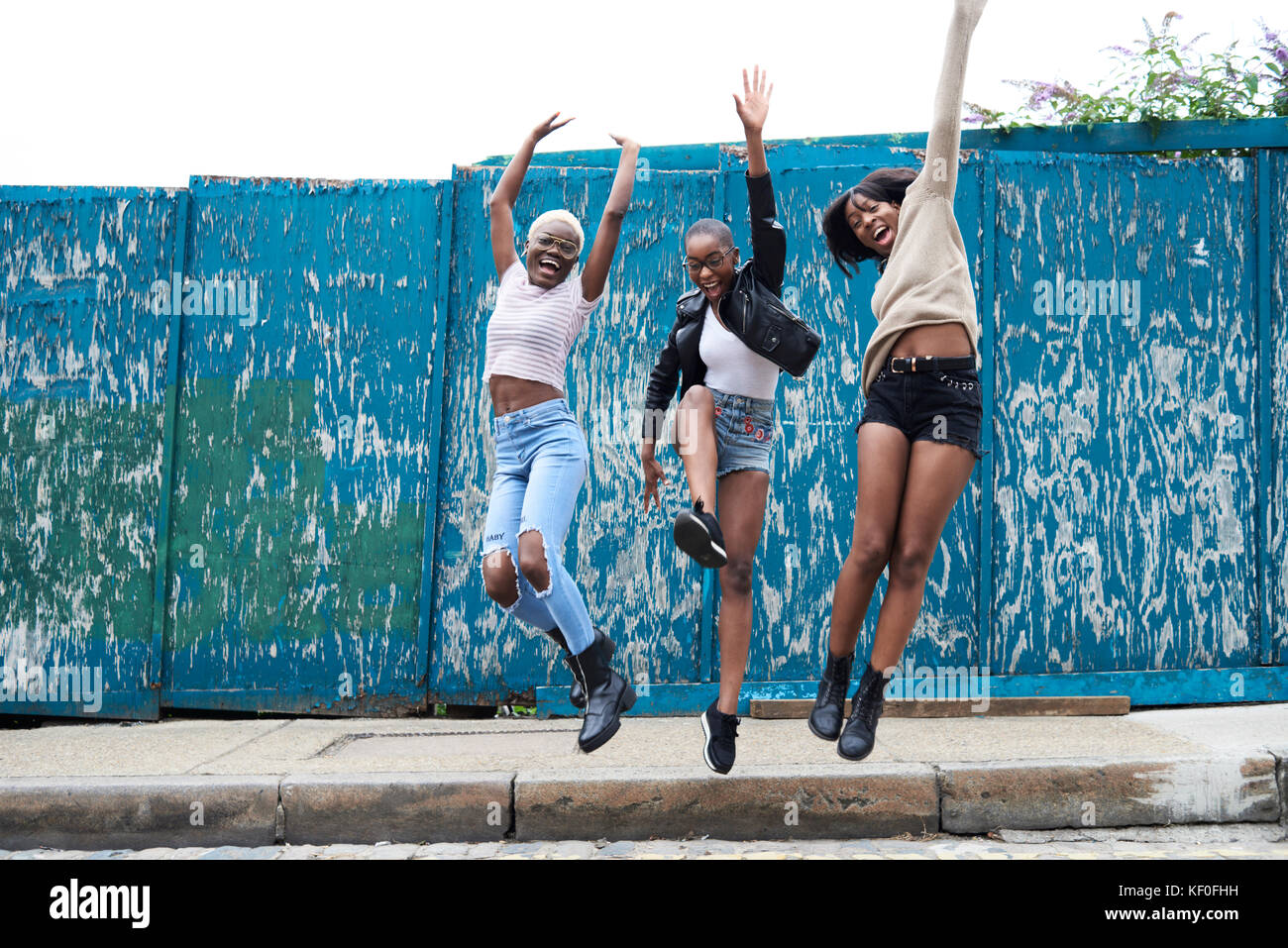 Three friends jumping in the air Stock Photo - Alamy