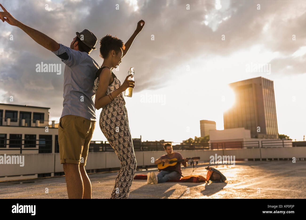 Young couple dancing on a rooftop party Stock Photo - Alamy