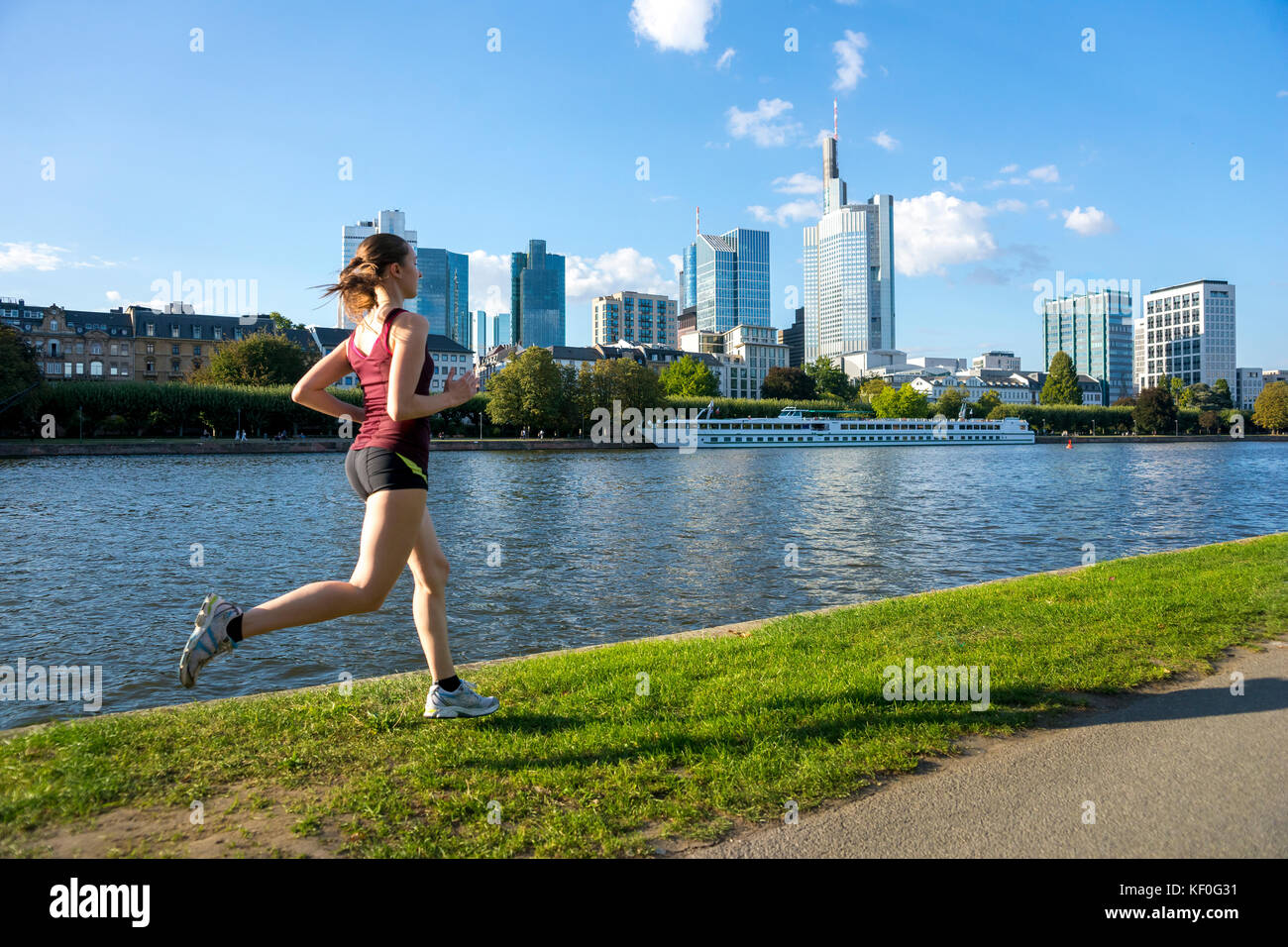 Germany, Frankfurt, young woman running at riverside Stock Photo - Alamy