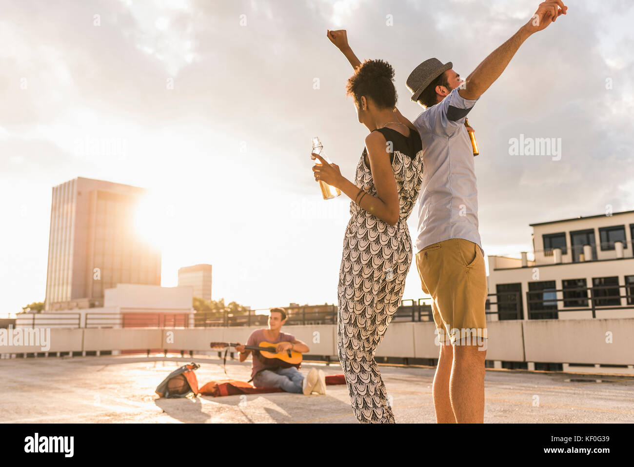 Young couple dancing on a rooftop party Stock Photo - Alamy