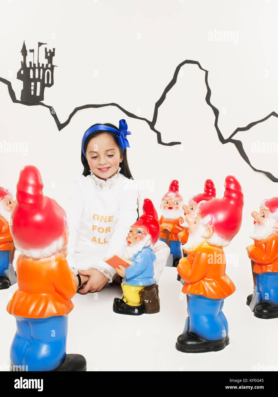 Portrait of little girl dressed up as Snow White with the seven dwarfs ...