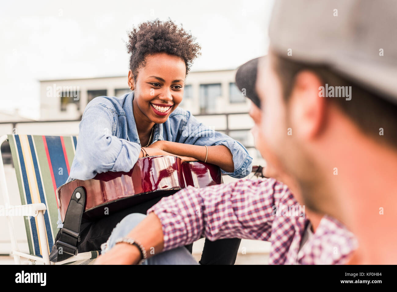 Three friends having a rooftop party Stock Photo - Alamy