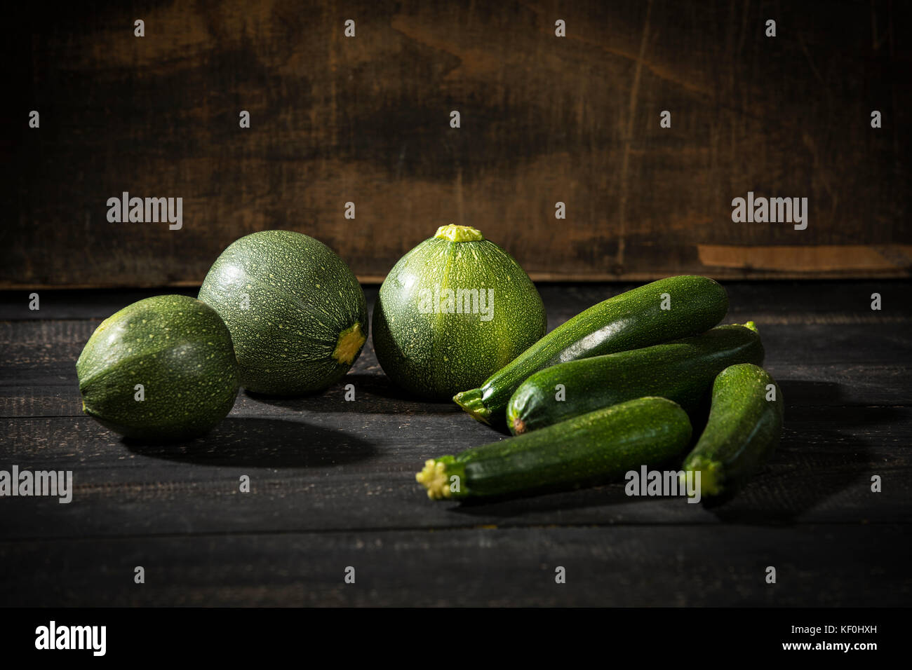 Eight ball squashes and courgettes on dark wood Stock Photo - Alamy