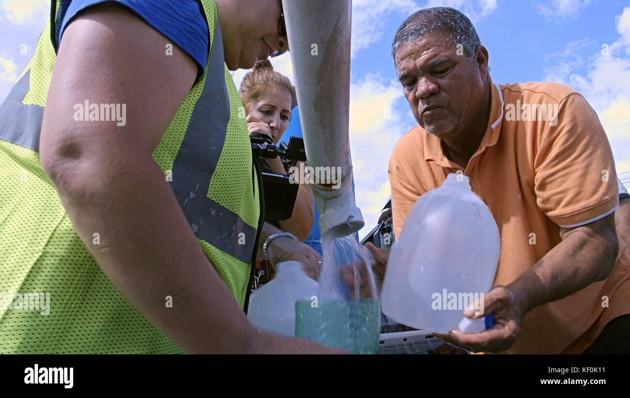 Puerto Rican residents collect clean water in the aftermath of ...
