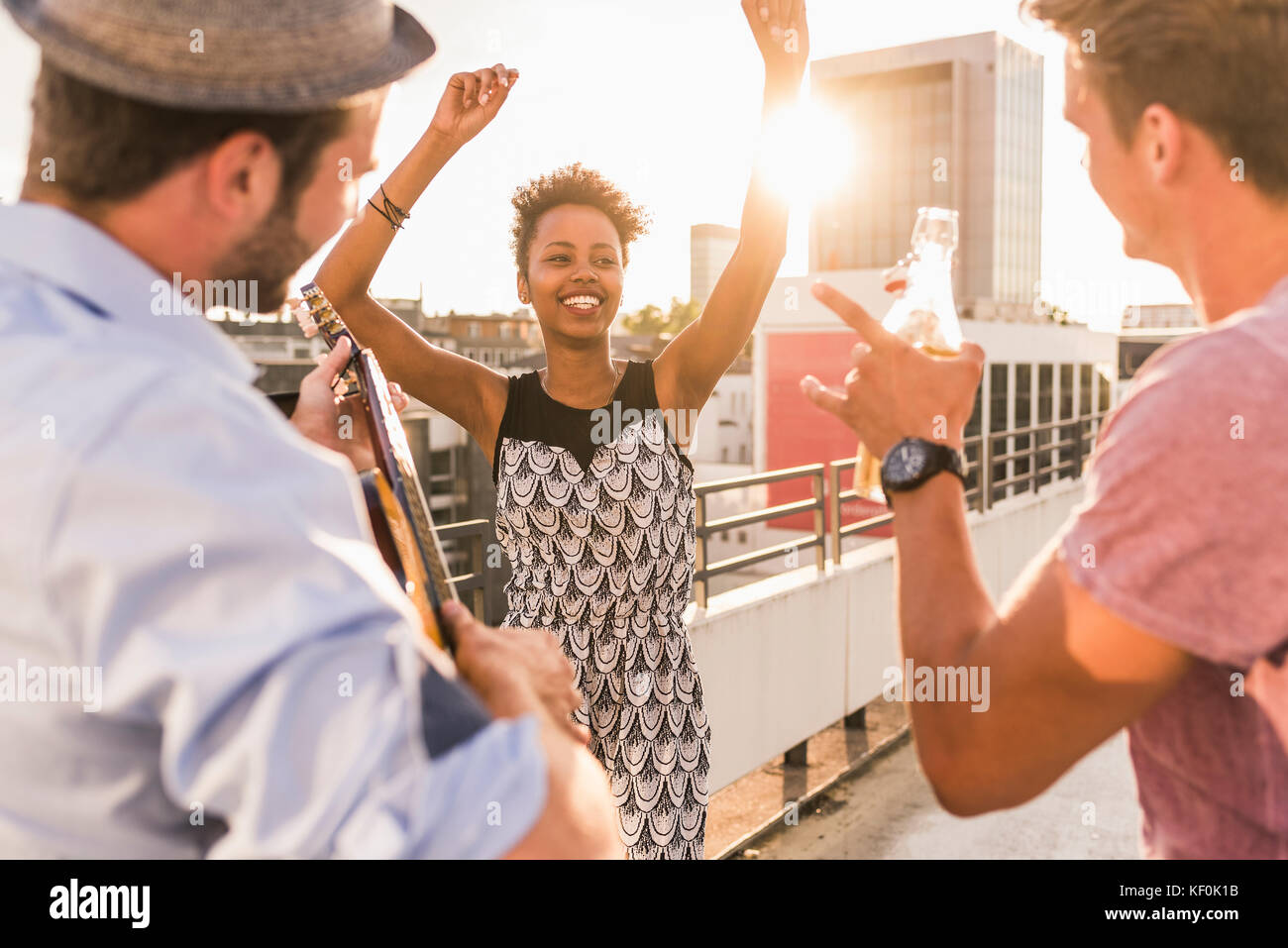 Young woman dancing on a rooftop party Stock Photo - Alamy