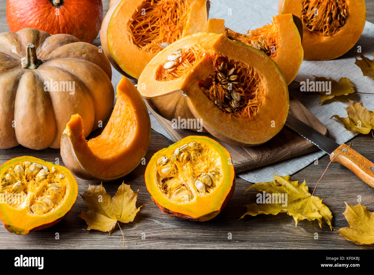 Sliced pumpkin with seeds on a wooden background. Close-up Stock Photo ...