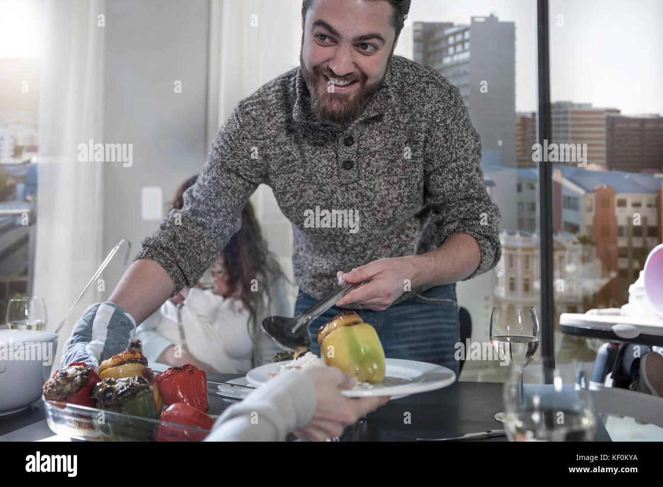 Smiling man serving food Stock Photo - Alamy