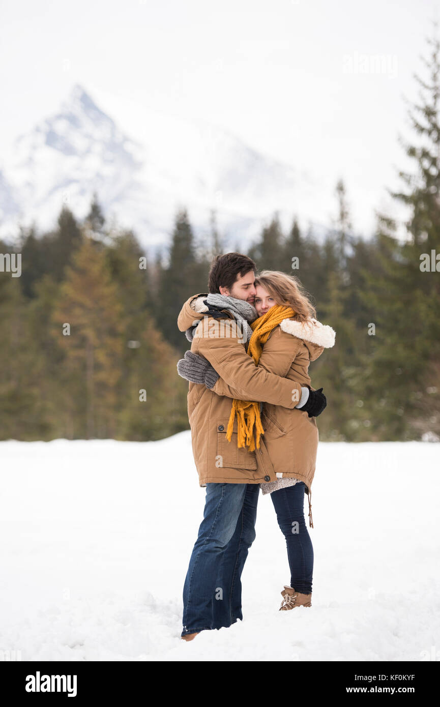 Young couple in love in winter landscape Stock Photo - Alamy