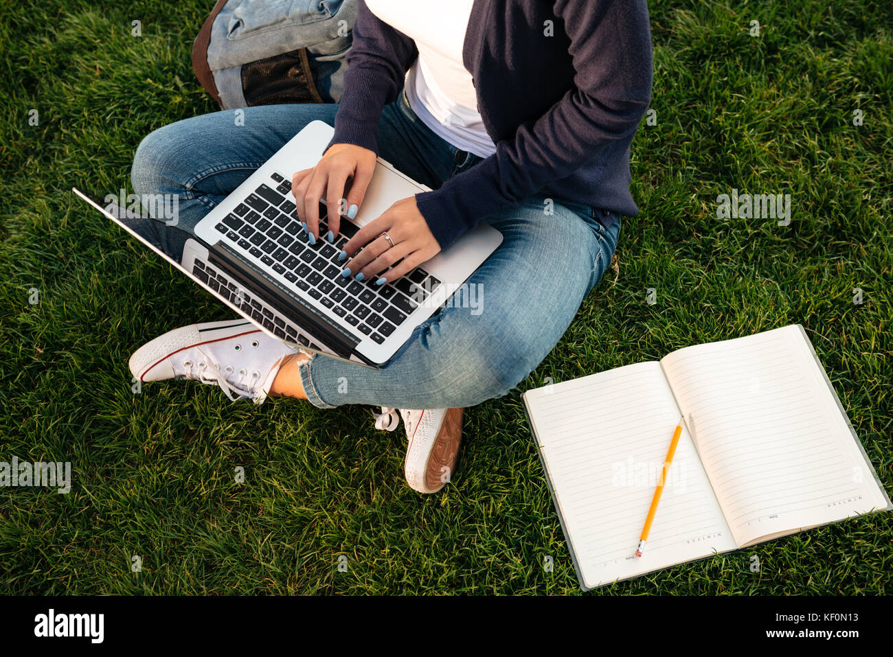 Top view of a female student studying on laptop computer while sitting ...