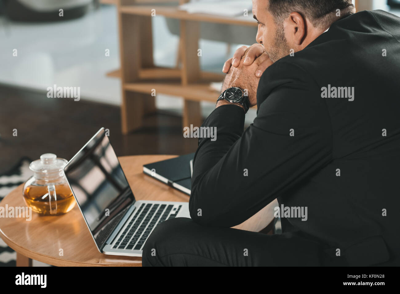 businessman looking at laptop Stock Photo - Alamy