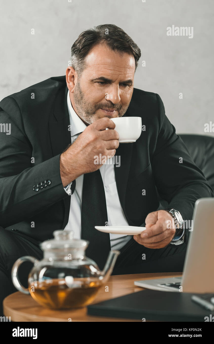 businessman drinking tea Stock Photo - Alamy