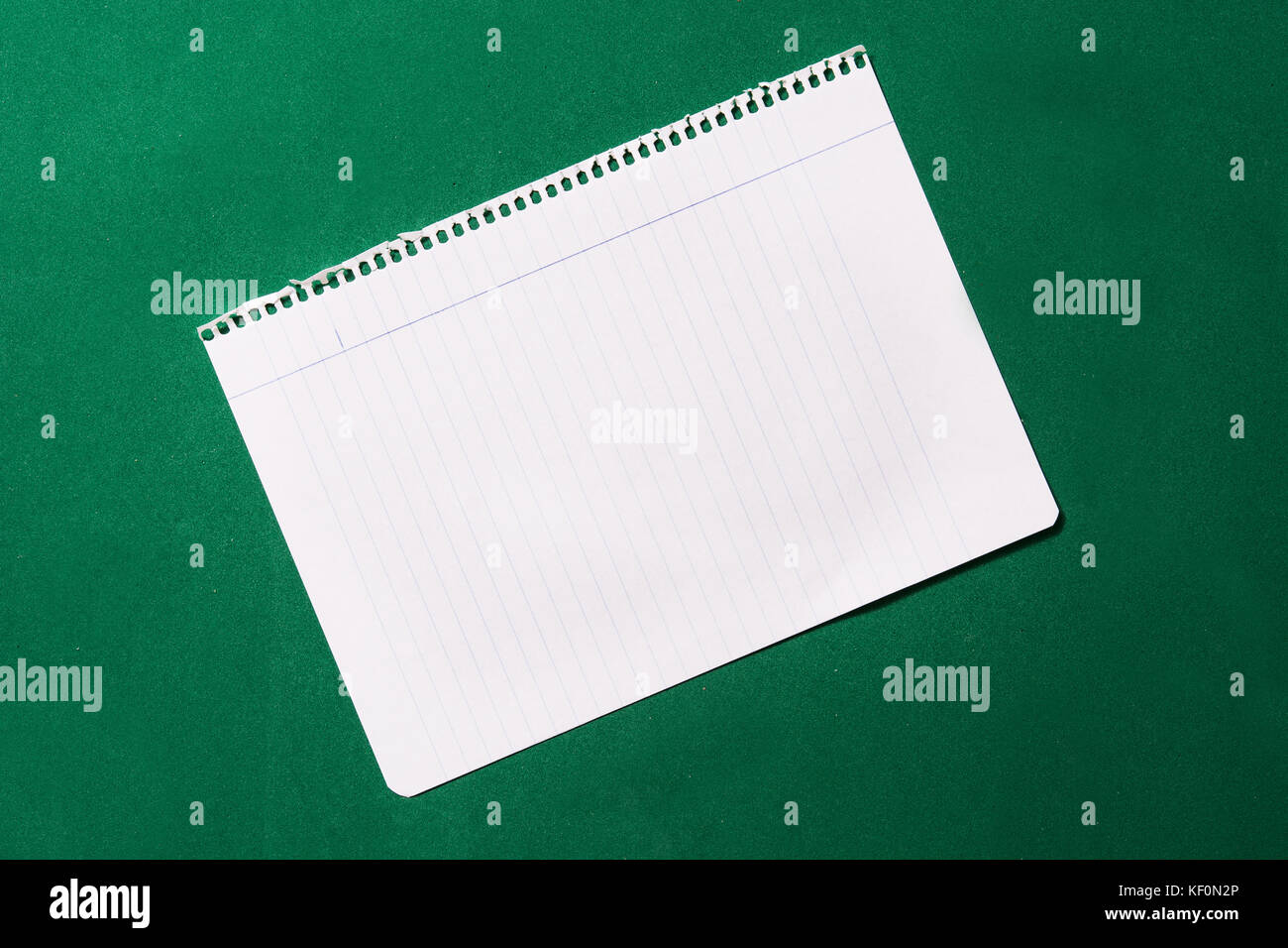 Notebook sheet on green background Stock Photo - Alamy