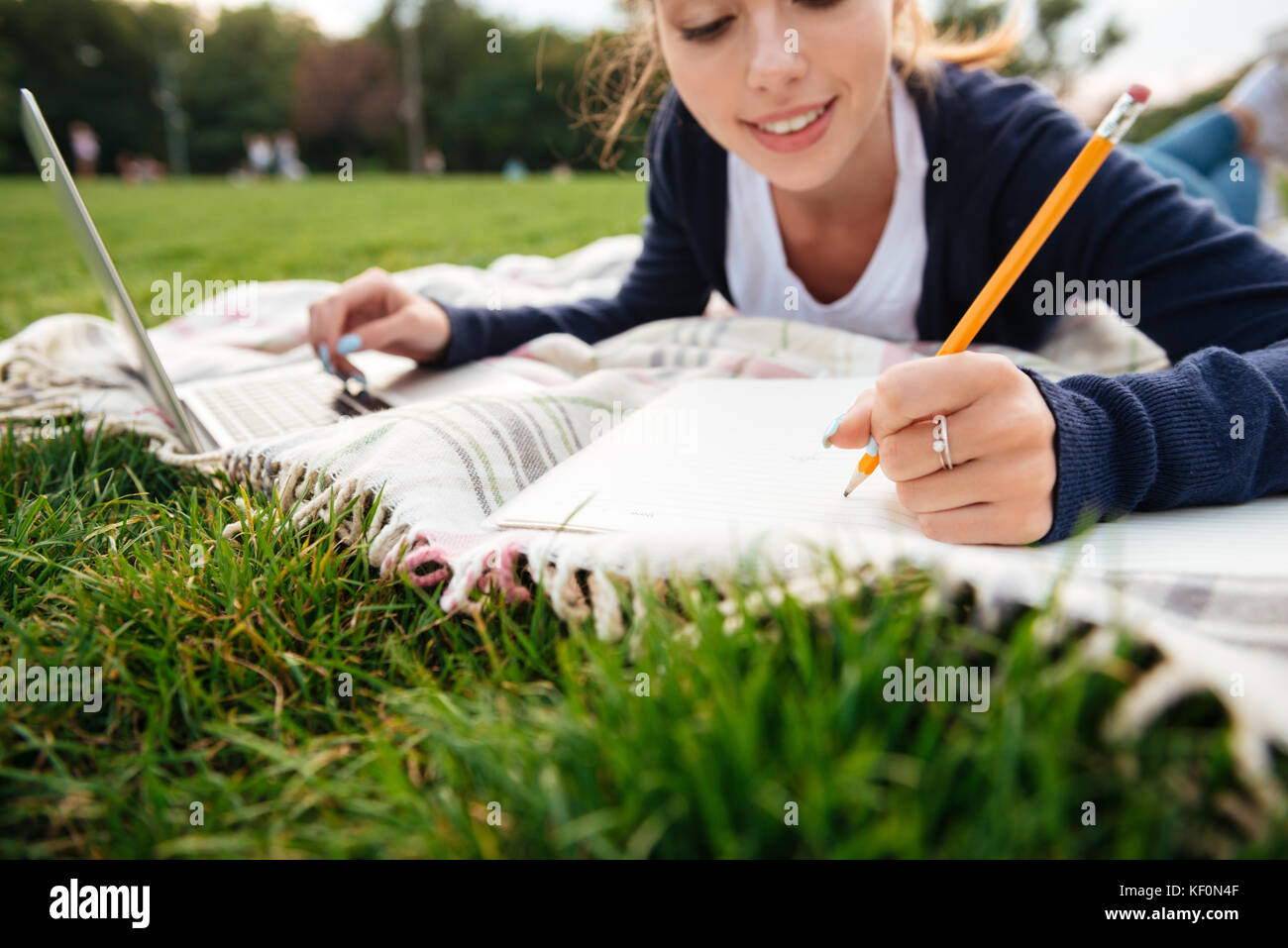 Close up portrait of a young pretty student girl doing homework with ...