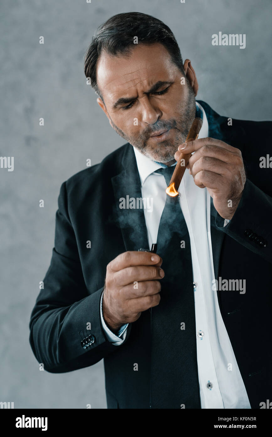businessman smoking cigar Stock Photo - Alamy