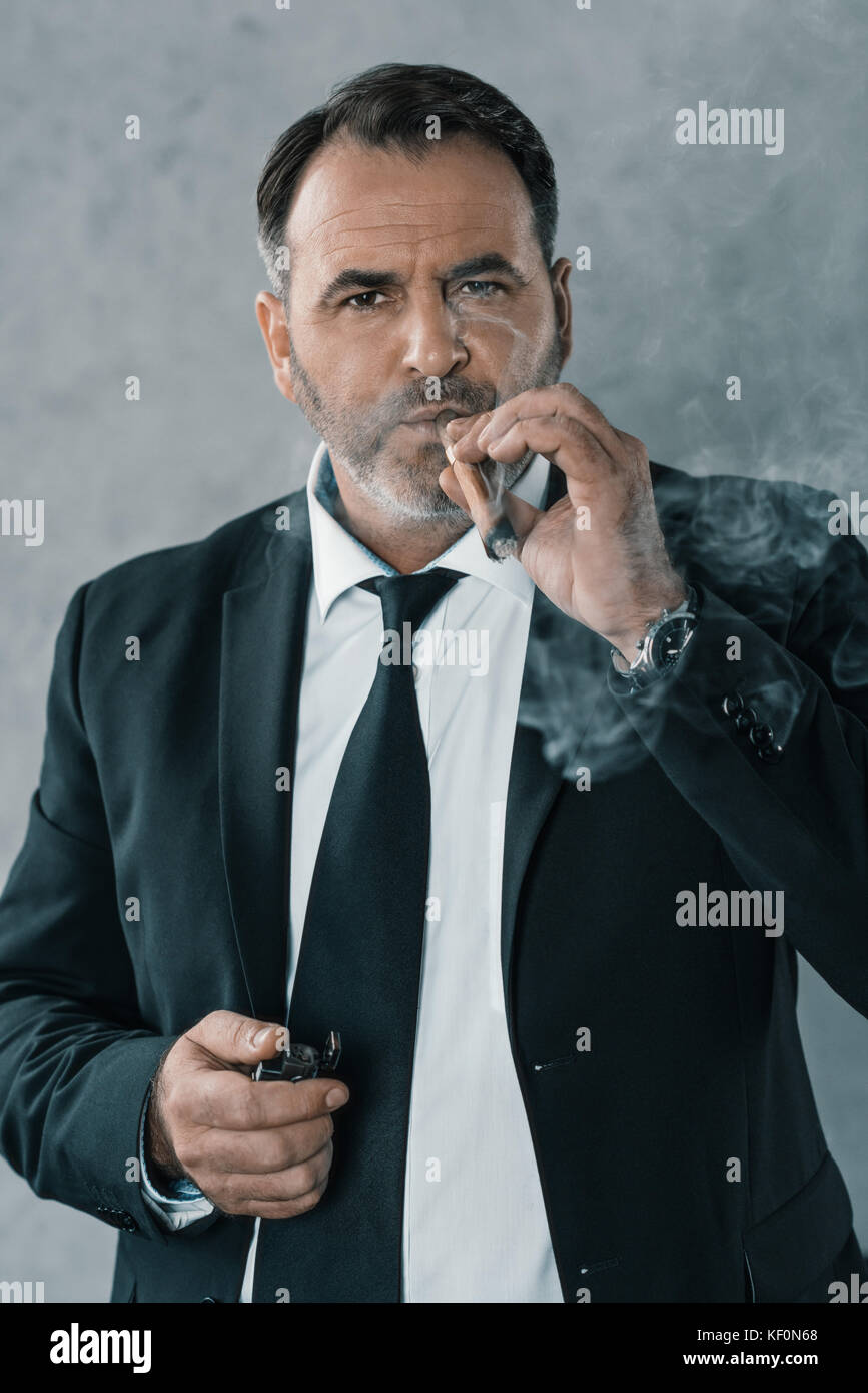businessman smoking cigar Stock Photo - Alamy